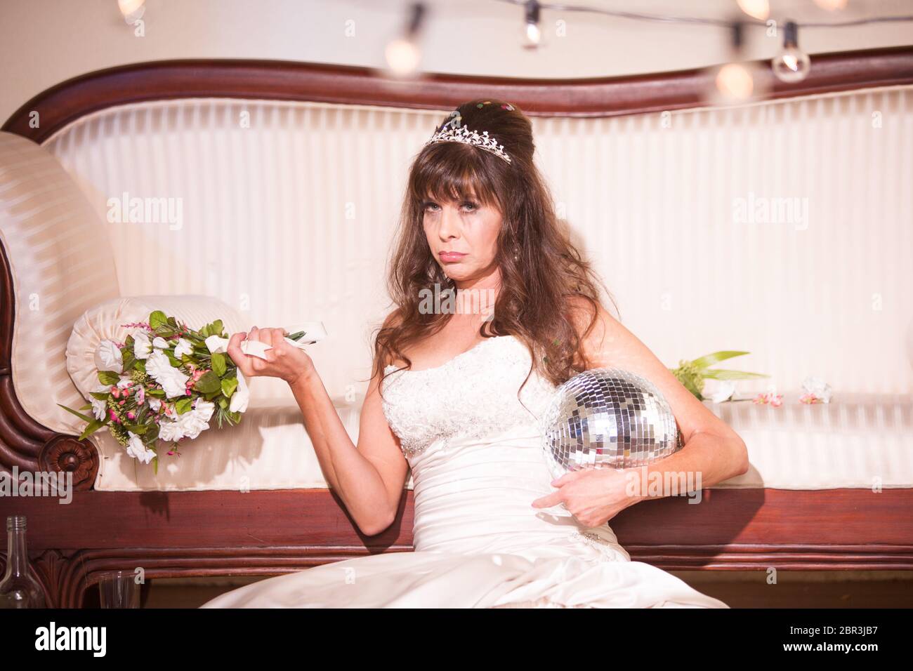 Unhappy bride with a disco ball Stock Photo - Alamy