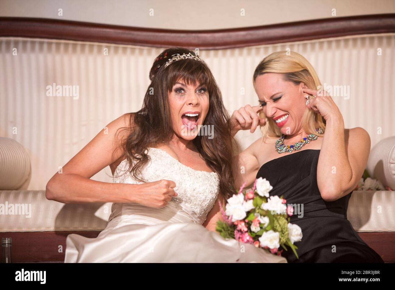 Friend with screaming bride at a wedding reception Stock Photo - Alamy