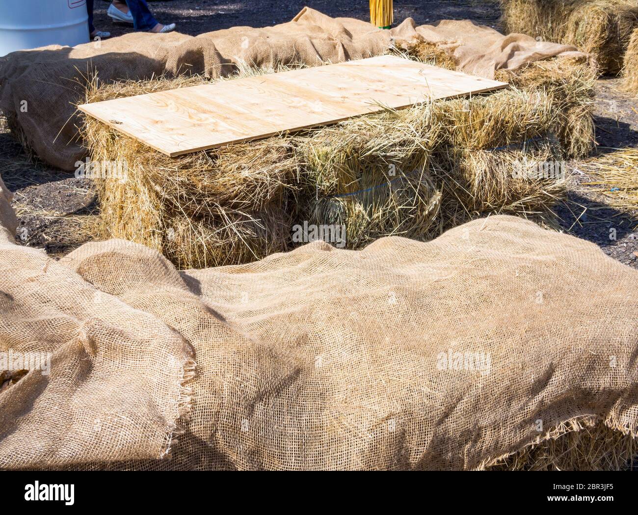 Table and benches made from straw bales Stock Photo - Alamy
