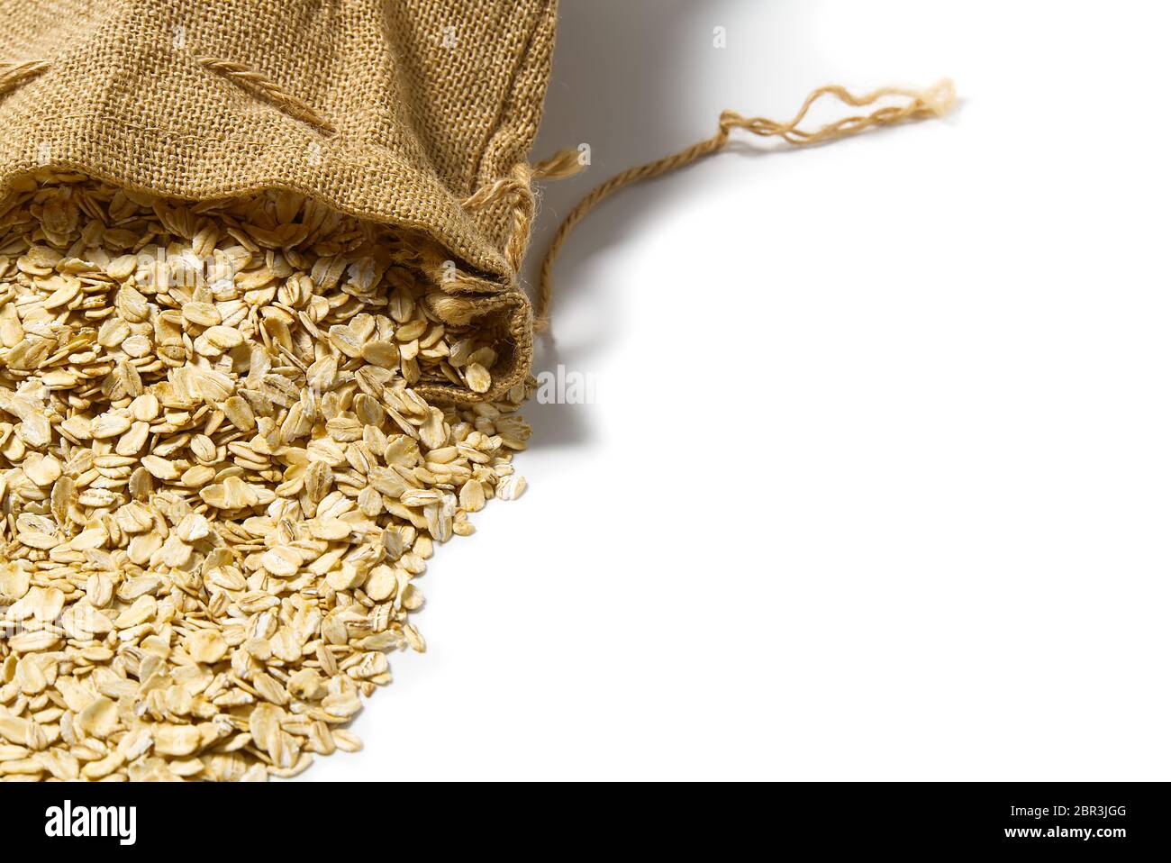 oatmeal spills out of a linen bag. dry natural oat flakes. Natural ...