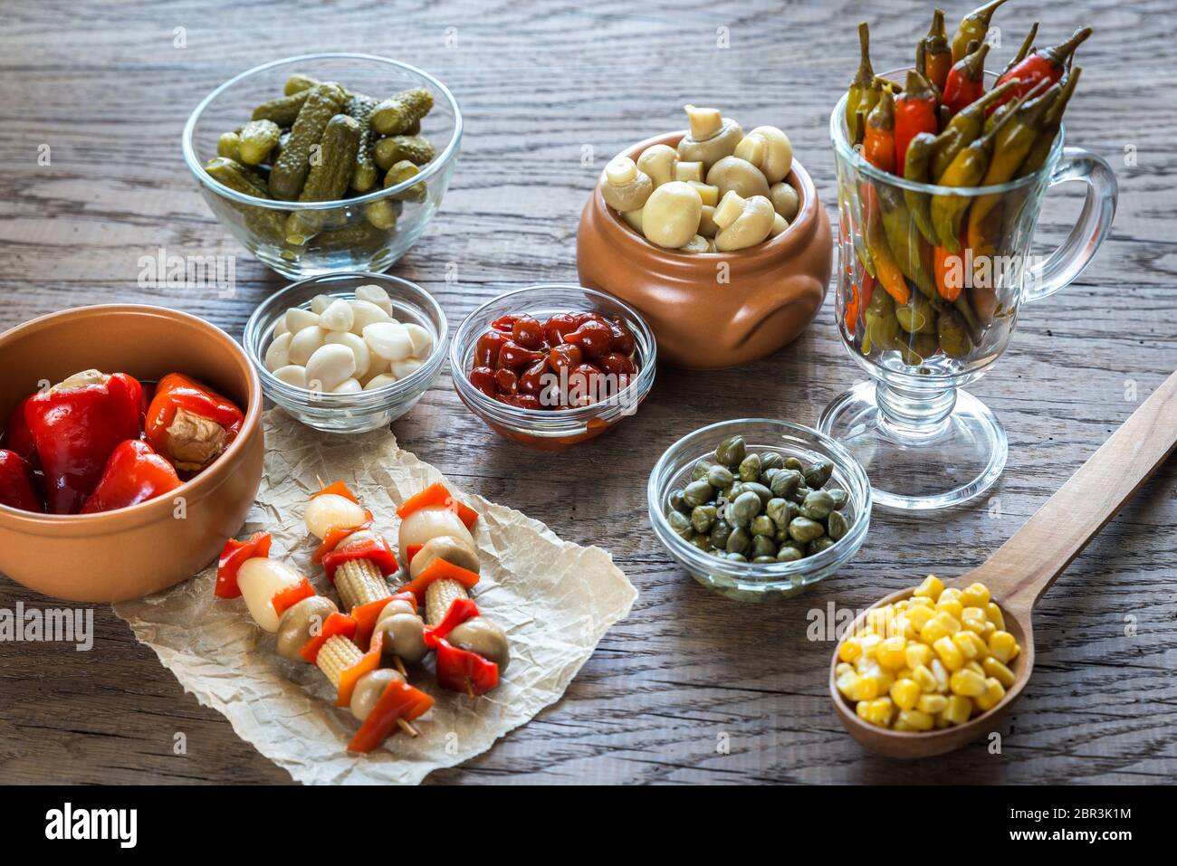 Pickled vegetables on the wooden background Stock Photo - Alamy