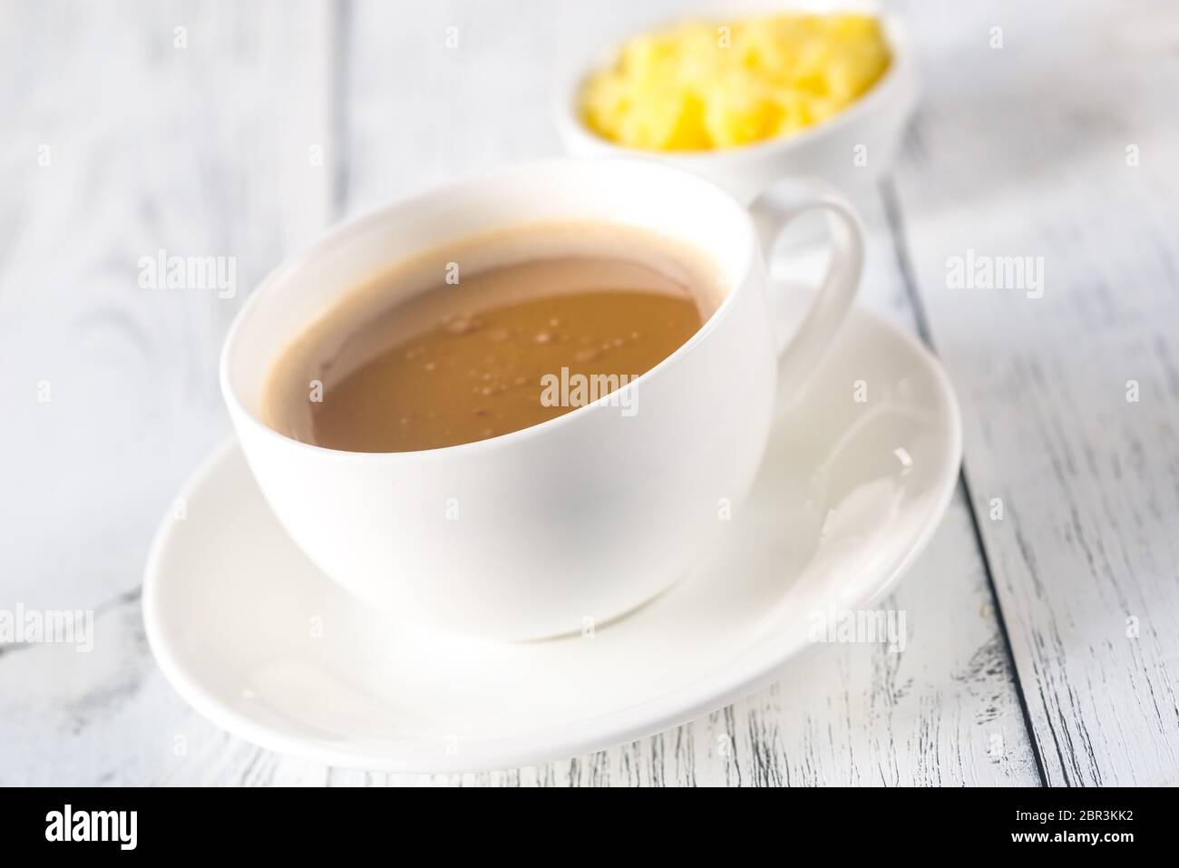 Cup of coffee with bowl of ghee Stock Photo - Alamy