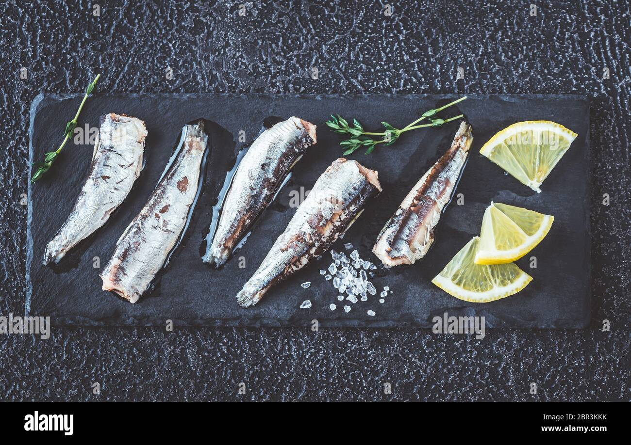 Sardines on the black stone board: top view Stock Photo - Alamy