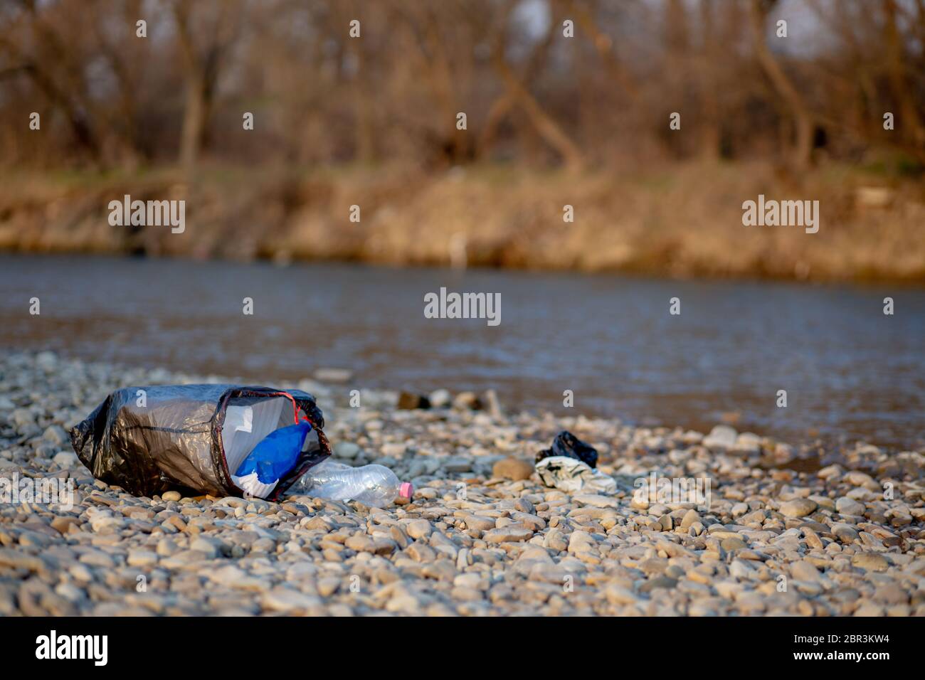 Garbage near the river. Environmental pollution shore Stock Photo - Alamy
