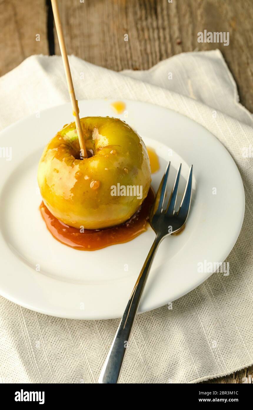 Caramelized apple on the wooden stick Stock Photo - Alamy