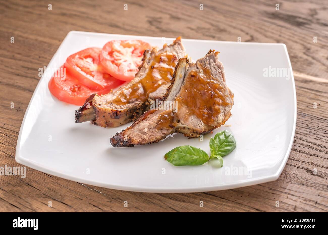 Portion of grilled pork ribs in barbecue sauce Stock Photo - Alamy