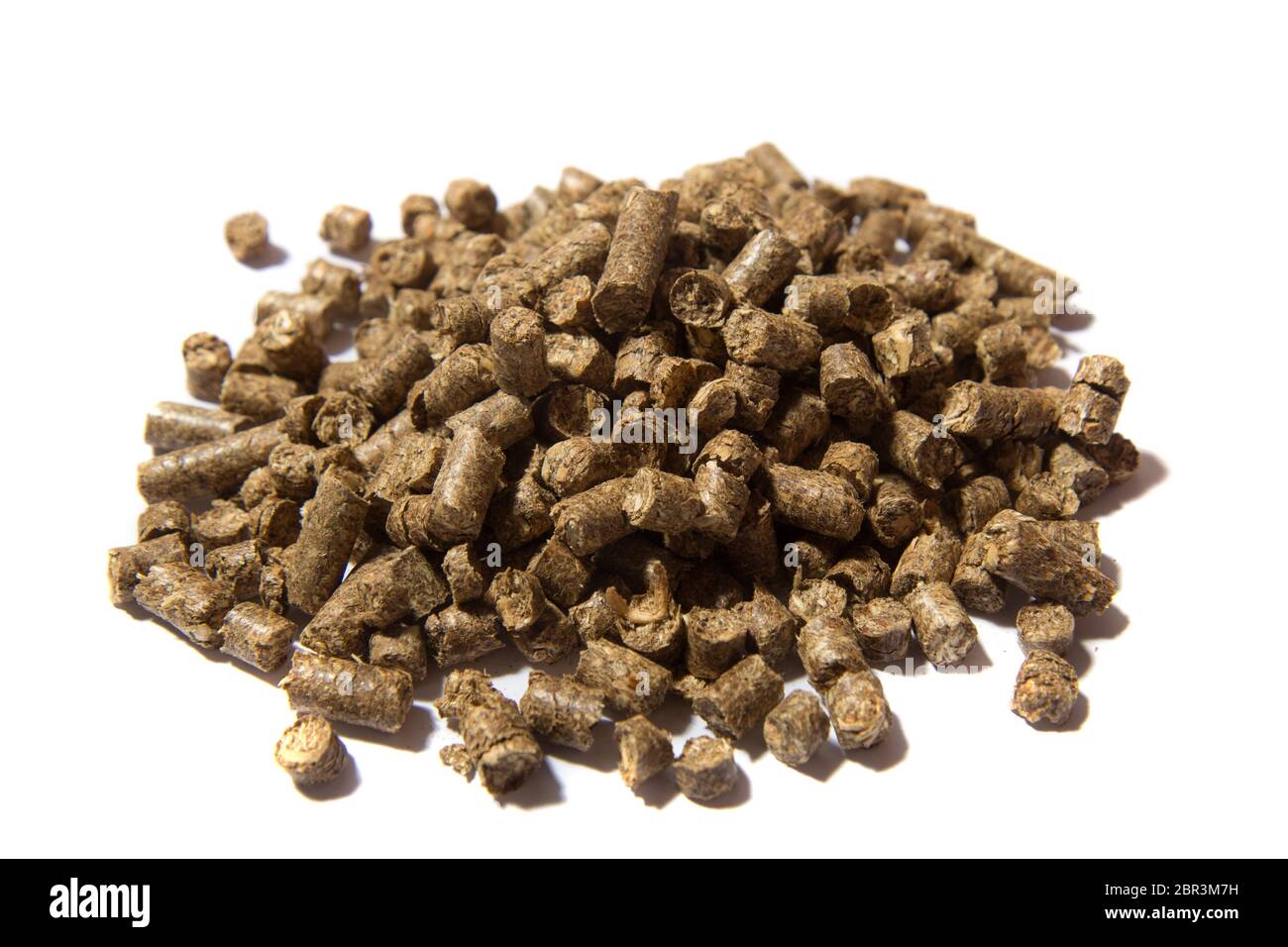 Light brown pressed solid wooden pellets granules on white background ...