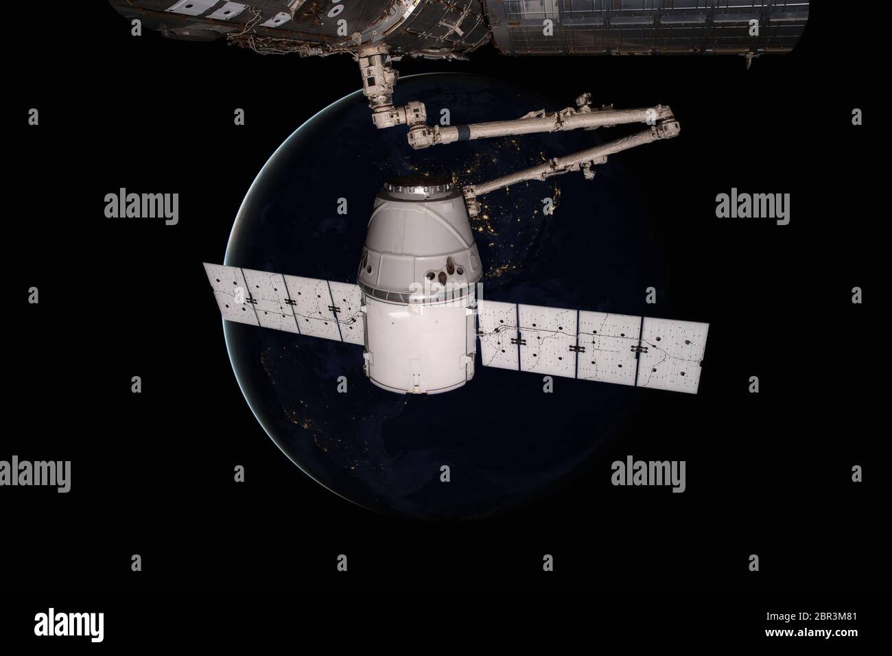 SpaceX Dragon orbiting the planet Earth. Elements of this image ...