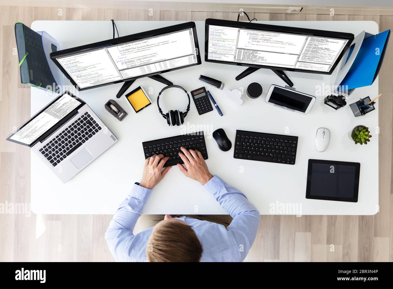 Computer programmer writing program code on computer in office Stock ...