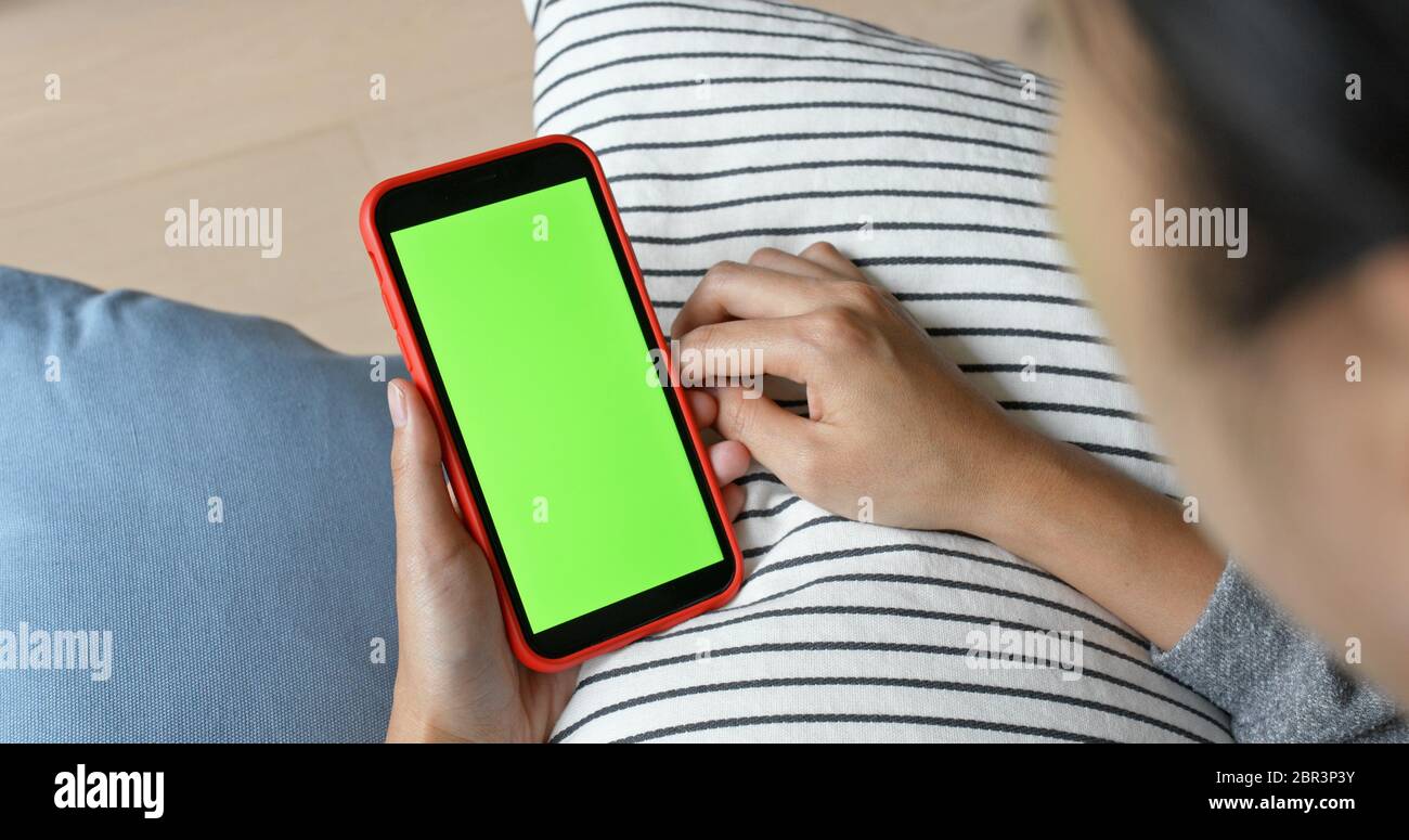 Woman use of mobile phone with green screen Stock Photo - Alamy