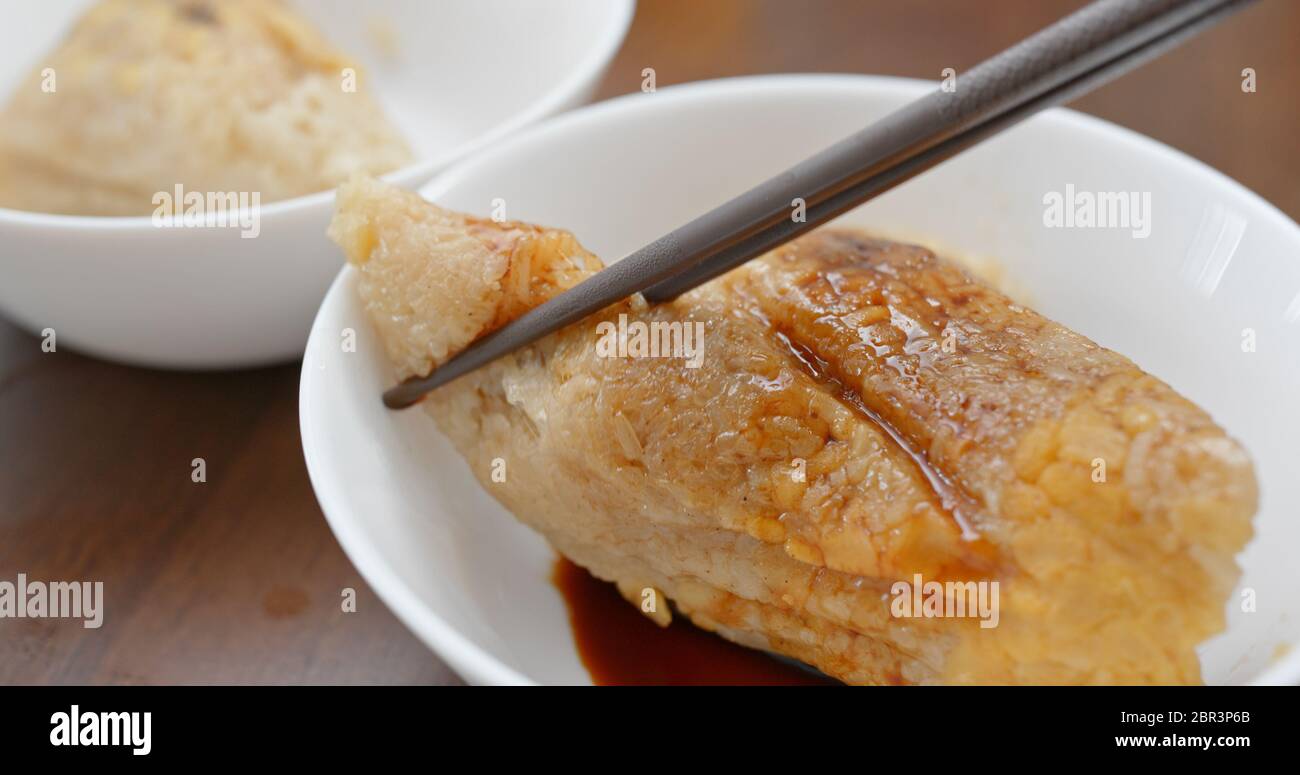 Eat with chopstick rice dumpling Stock Photo - Alamy