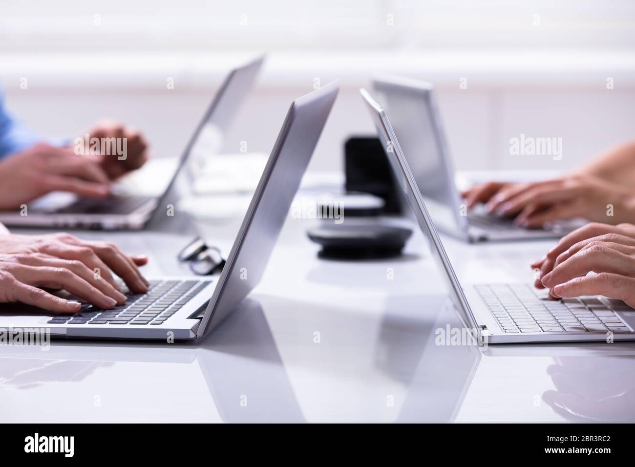 Close-up Of A Businessman Hands On Laptops Keypads On Desk In Office ...