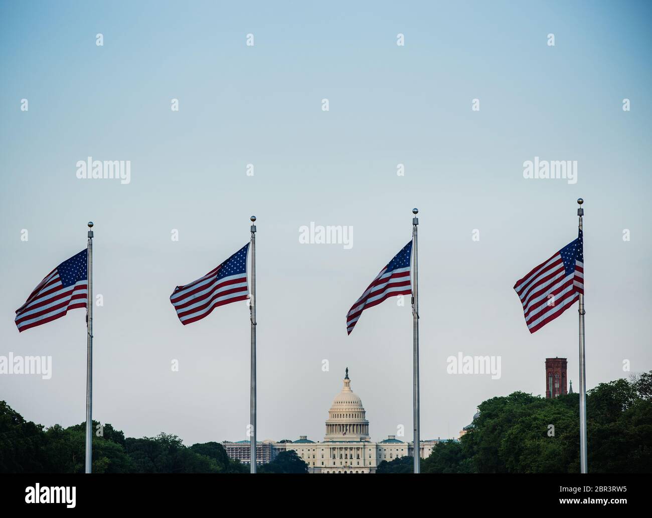American flags with the United States Capital building in the ...