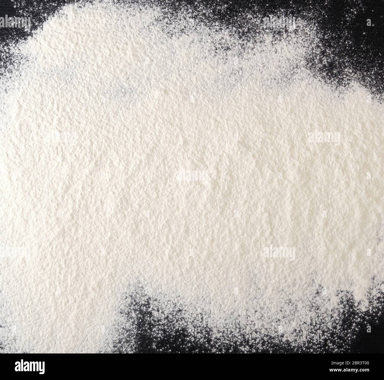 sprinkled white flour on the black table, top view, full frame Stock ...