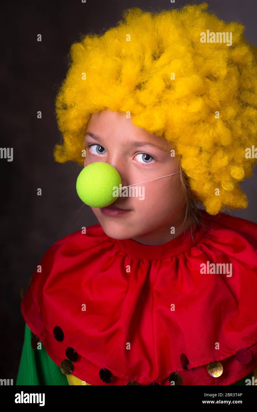 portrait of seriously looking little clown prepared for performance ...