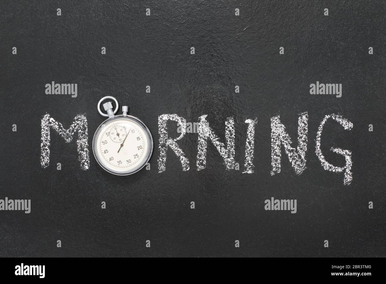 morning word handwritten on chalkboard with vintage precise stopwatch ...