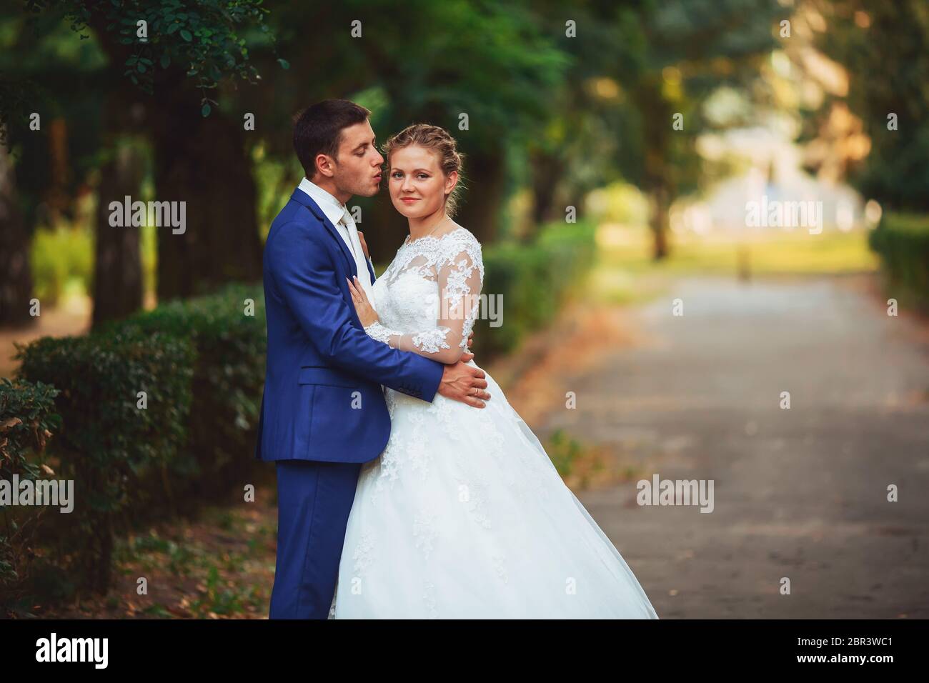 Wedding couple, bride in white wedding dress and groom walking in the ...