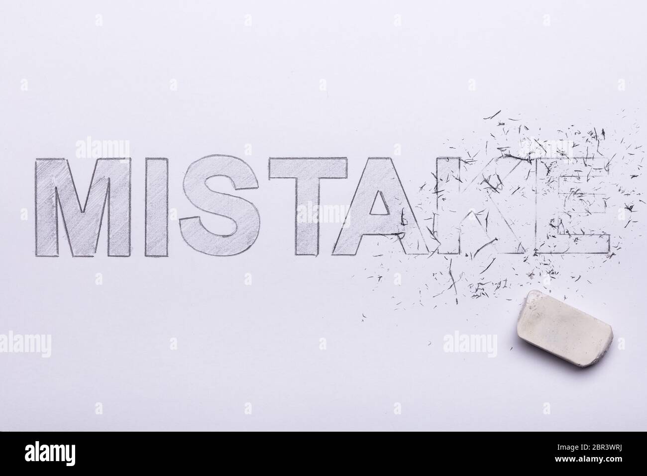 Close-up Of Pencil Eraser Erasing Mistake Word On White Paper Stock ...