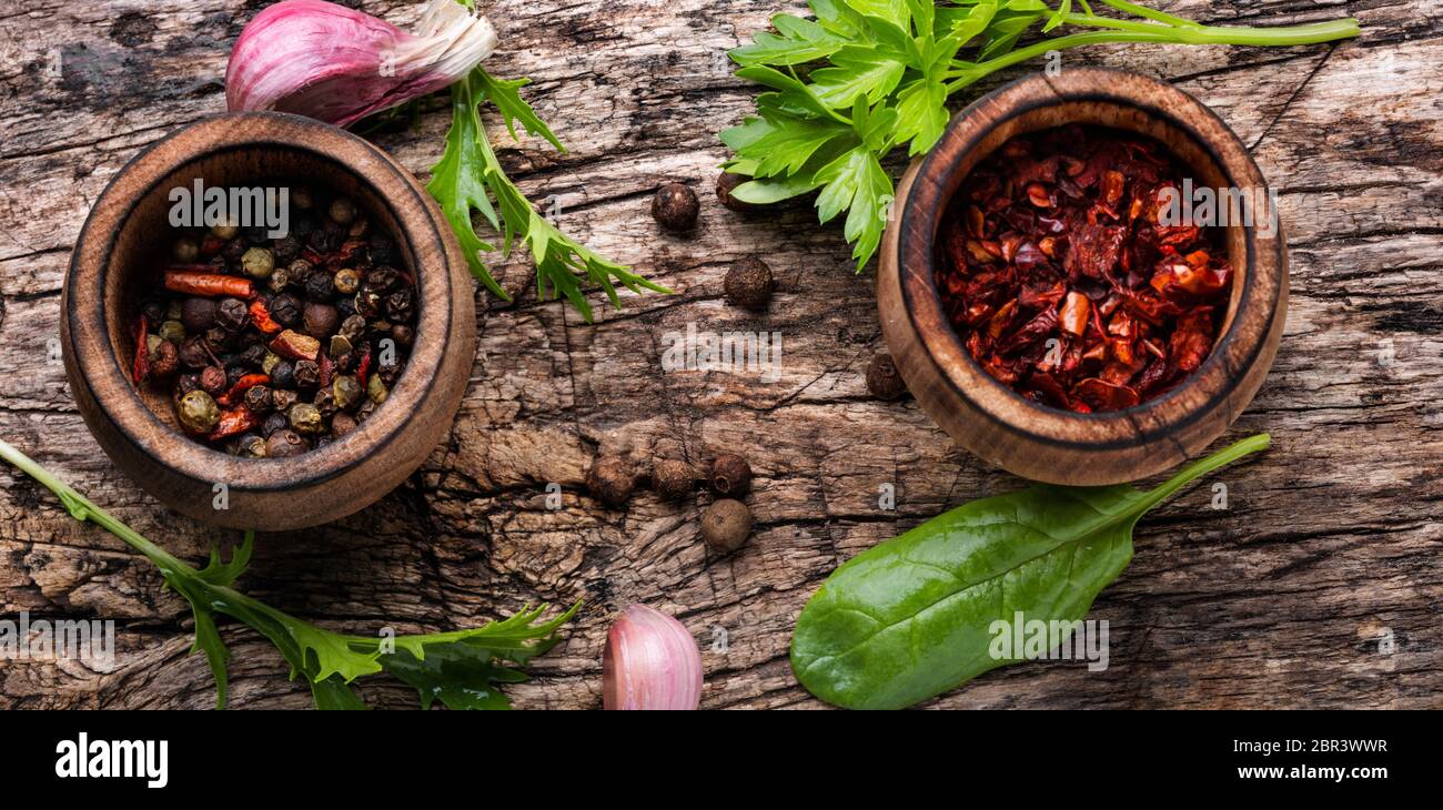 Herbs and spices on dark rustic kitchen table Stock Photo - Alamy