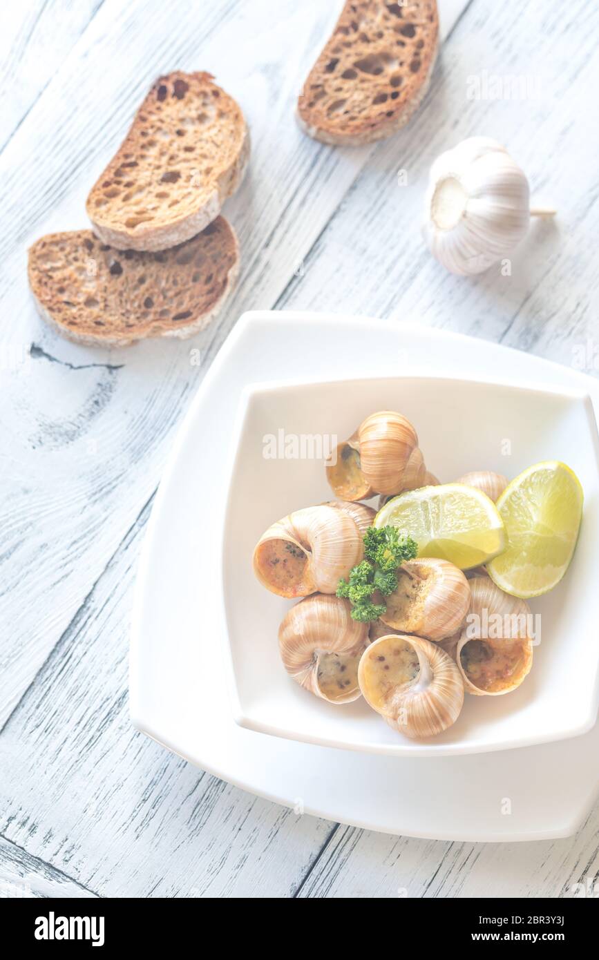Portion of cooked snails Stock Photo - Alamy