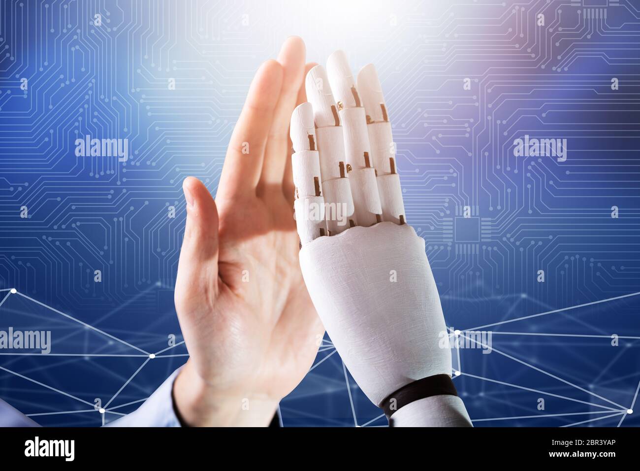 Close-up Of Robot And Man Giving High Five Against Digital Background ...
