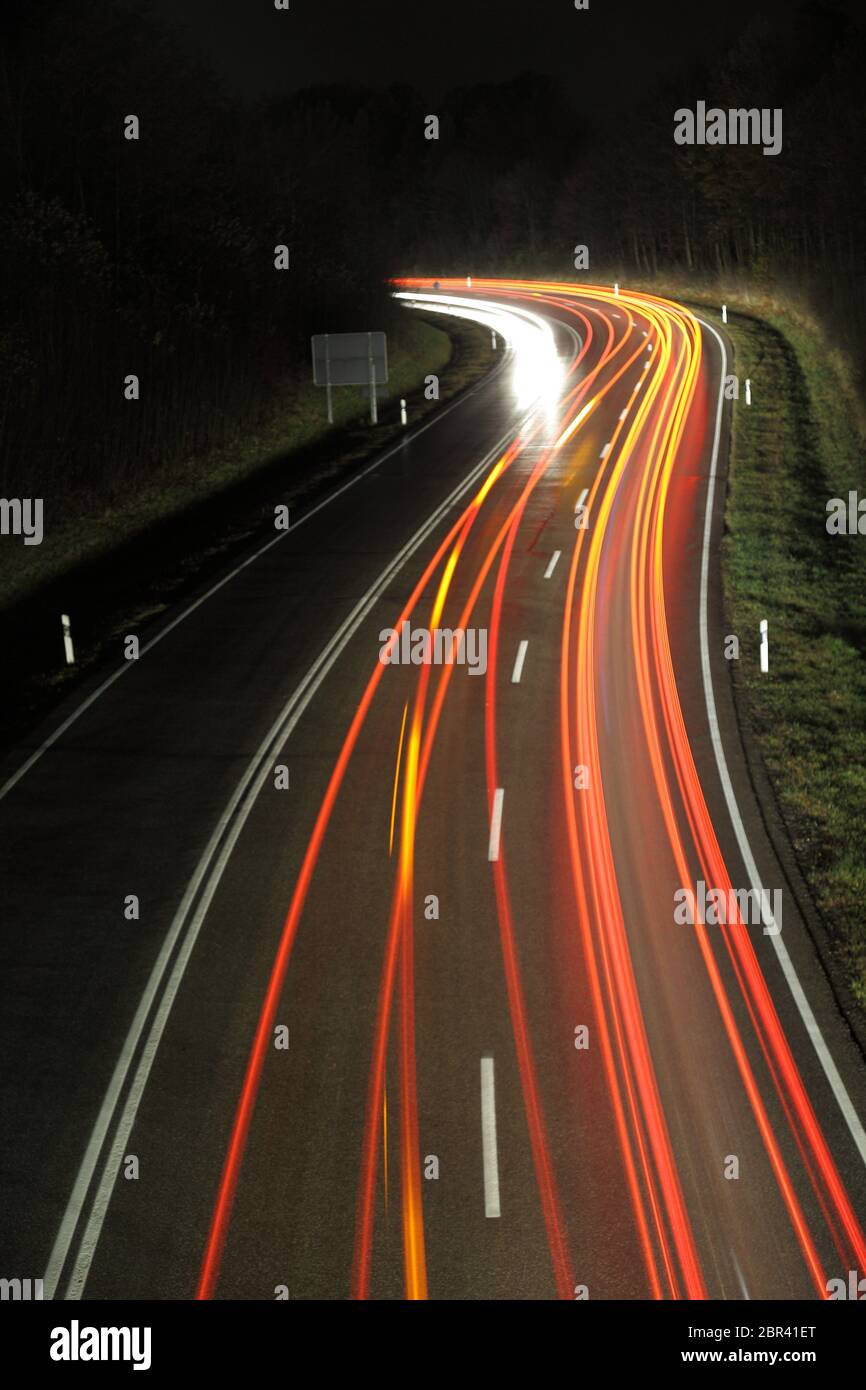 some different colored lights on a road in the night Stock Photo - Alamy