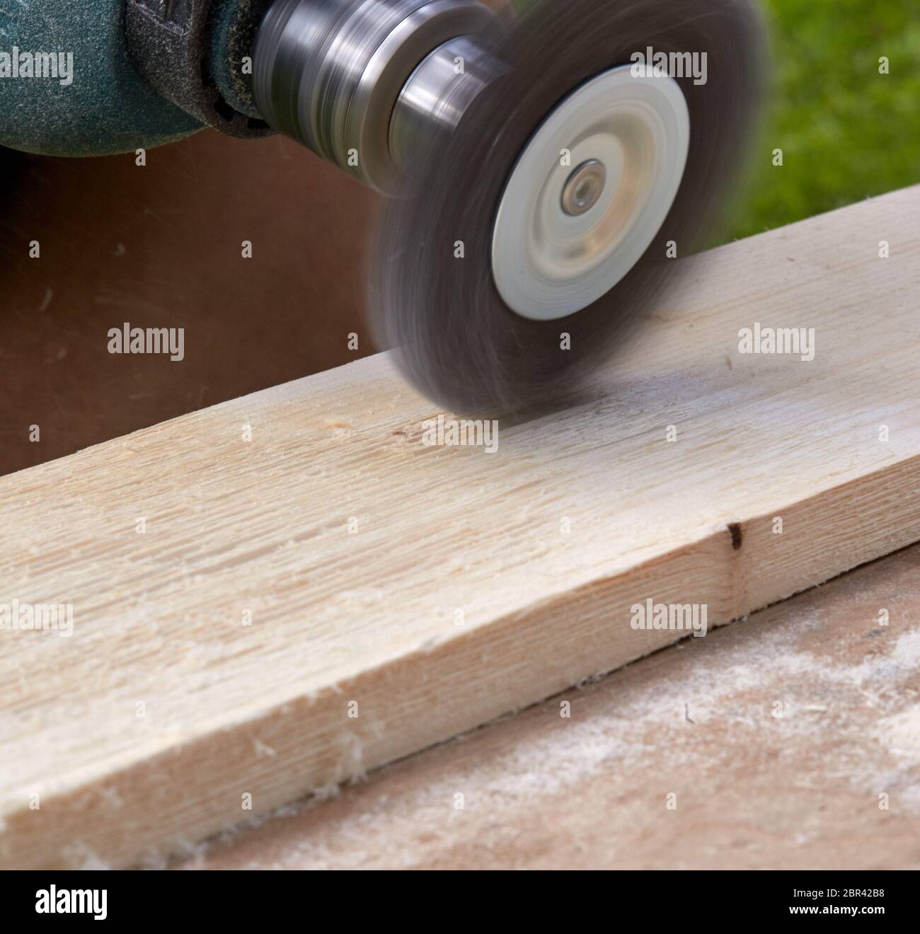 The brushing process of wooden plank. Male hand is holding brushing ...