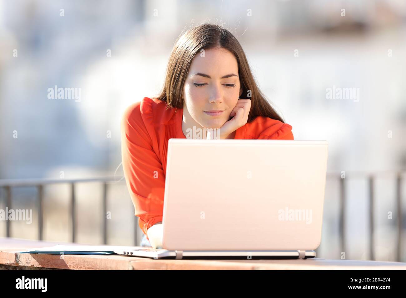 Front view of an entrepreneur watching online laptop content in a ...
