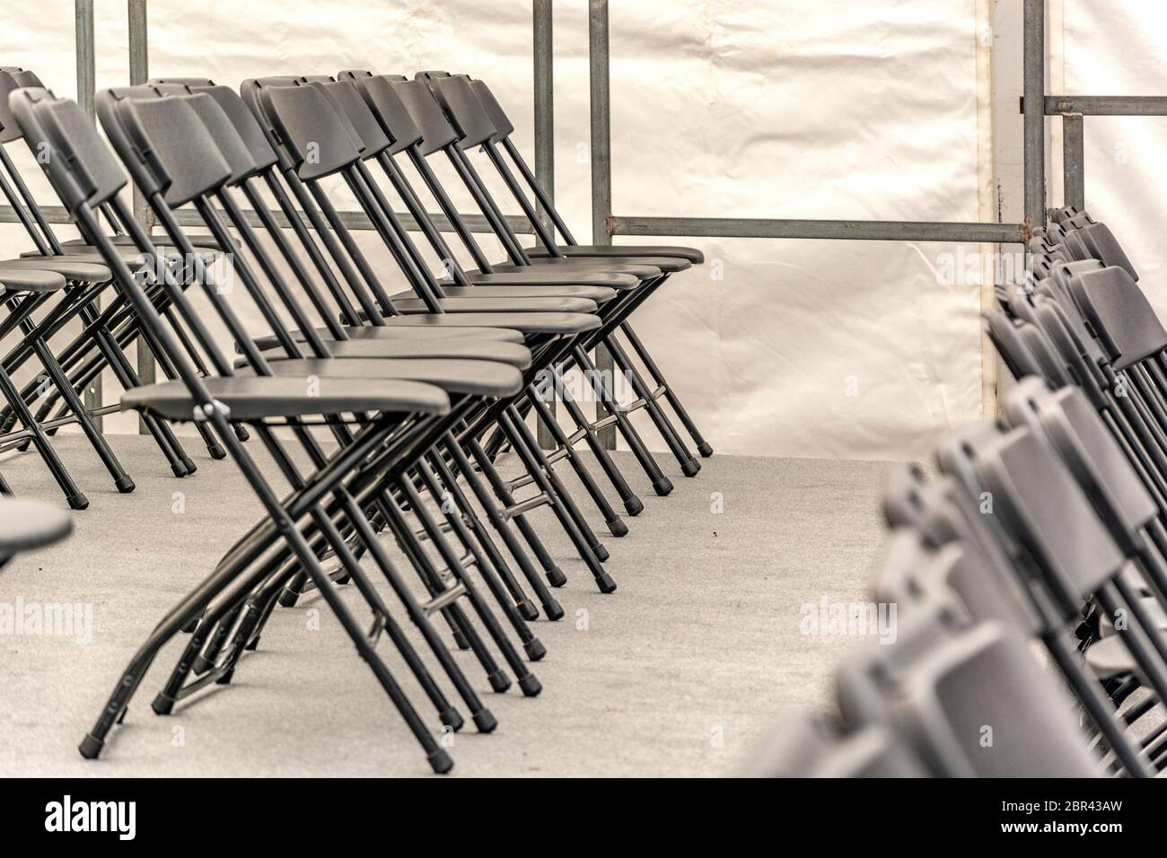 Rows of black folding chairs empty in a conference room Stock Photo - Alamy