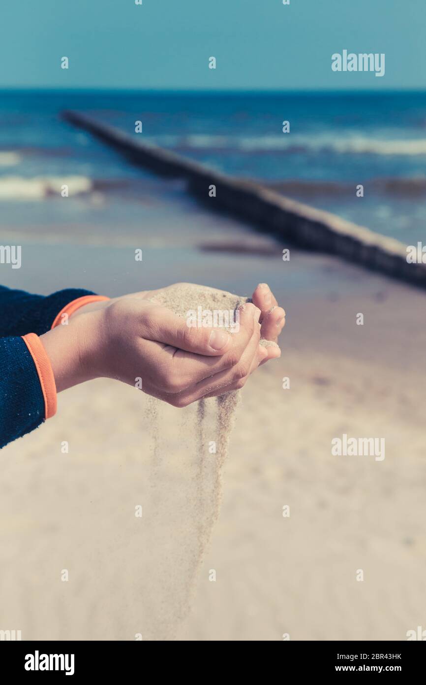 Child hands through sand hi-res stock photography and images - Alamy