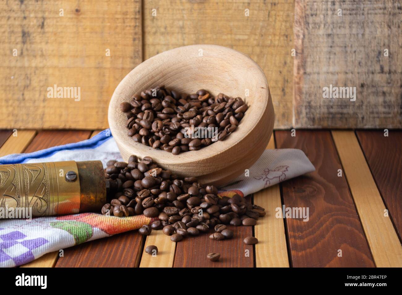 Coffee ready to be milled with old grinder. Coffee is in the table ...