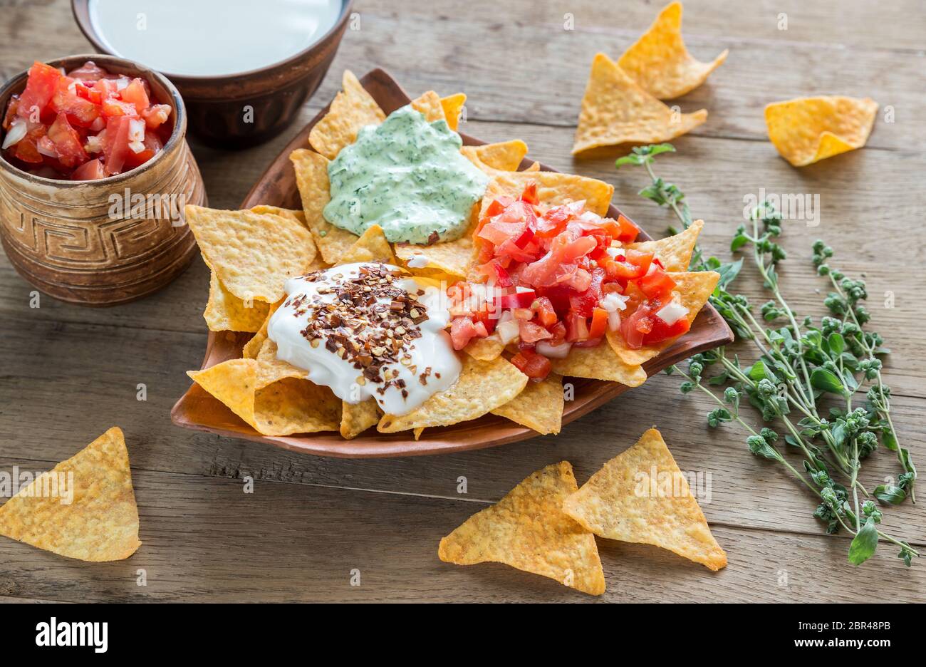Cheese nachos with different types of sauce Stock Photo - Alamy