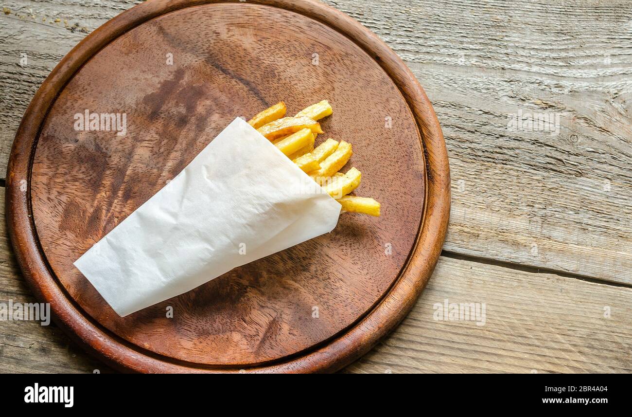 French fries in a paper wrapper Stock Photo - Alamy