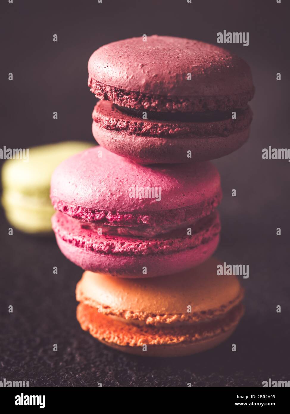 Colorful macarons on the dark background Stock Photo - Alamy