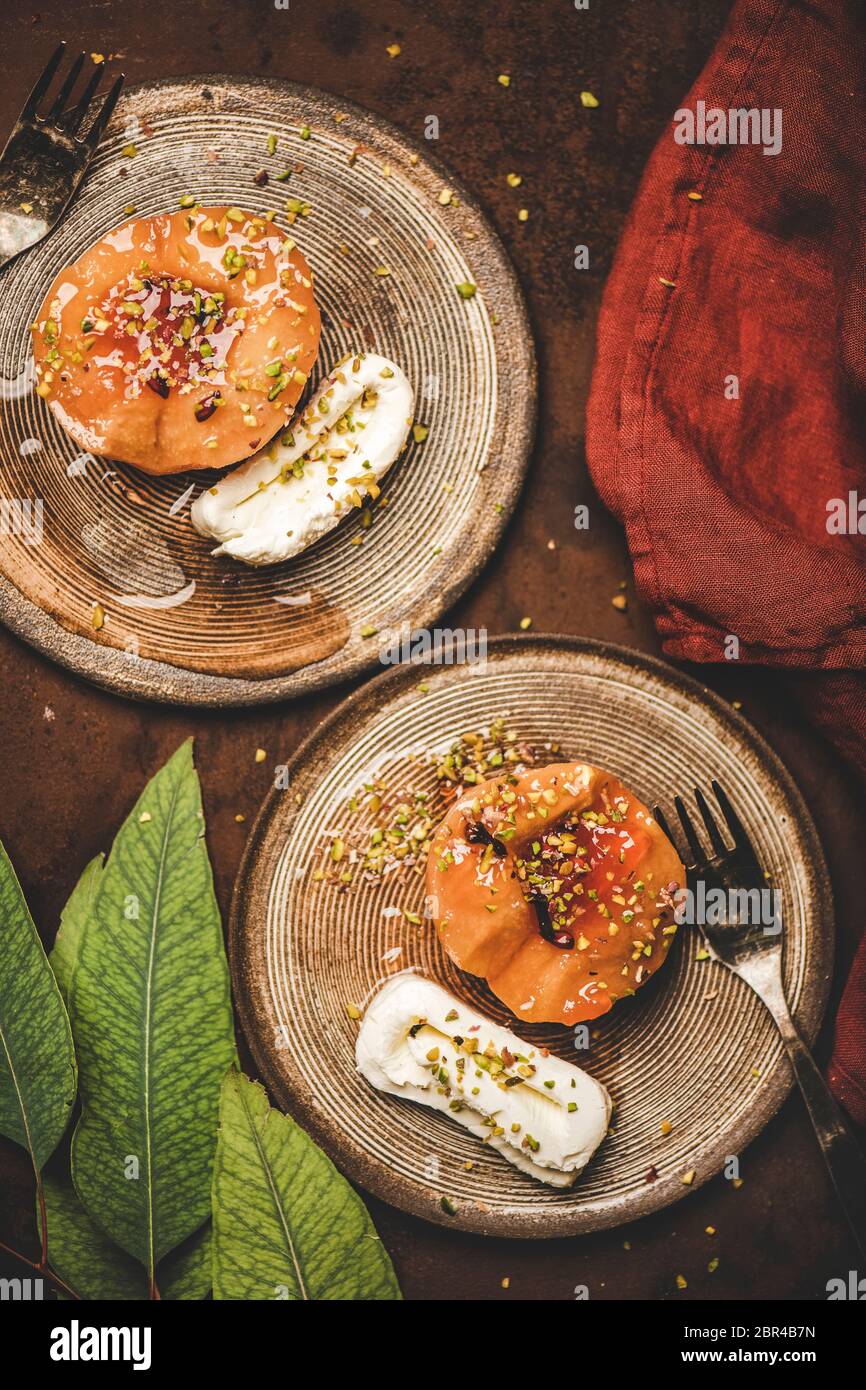 Flat-lay of Turkish traditional dessert with sweet quince boiled in ...