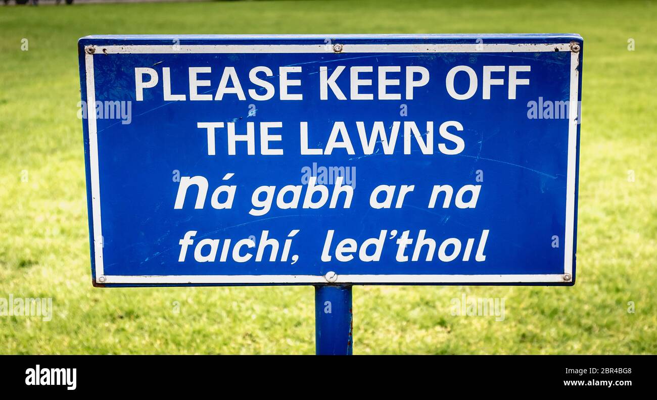 Blue Sign Please Keep Off The Laws In English And Irish On A Lawn Stock blue-sign-please-keep-off-the-laws-in-english-and-irish-on-a-lawn-stock