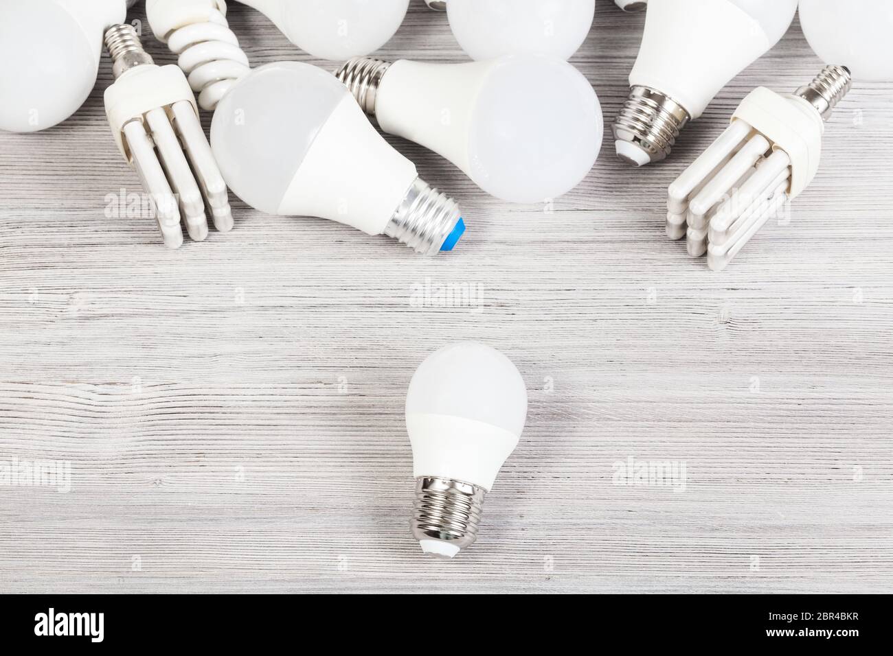 top view of white LED bulb light and several energy-saving lamps on ...