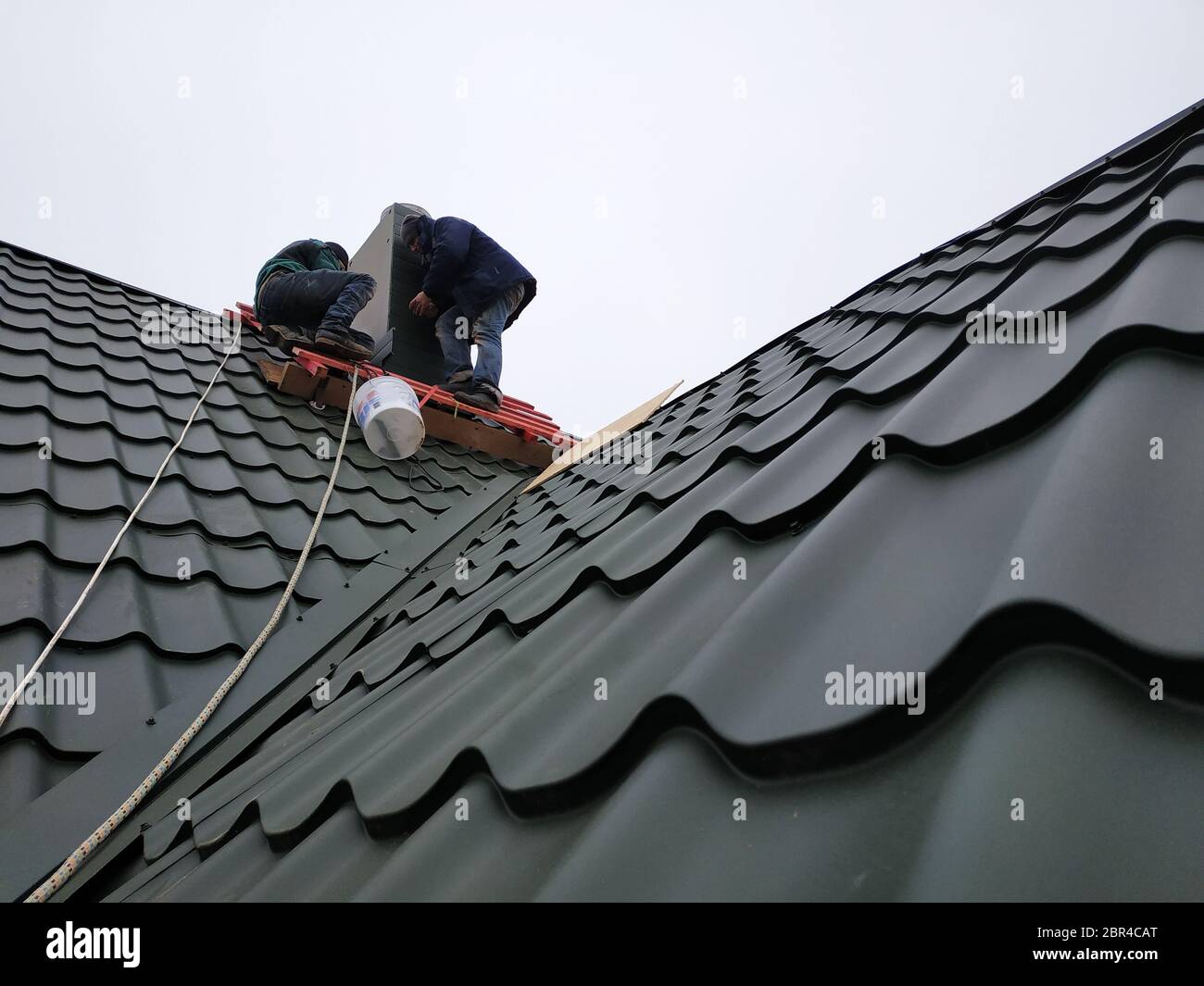 Working with roofing material, metal roof, hand tools screwdriver.2020 ...
