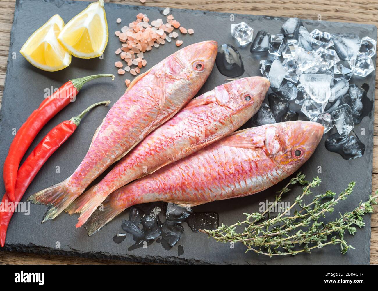 Raw red mullet with ingredients Stock Photo - Alamy