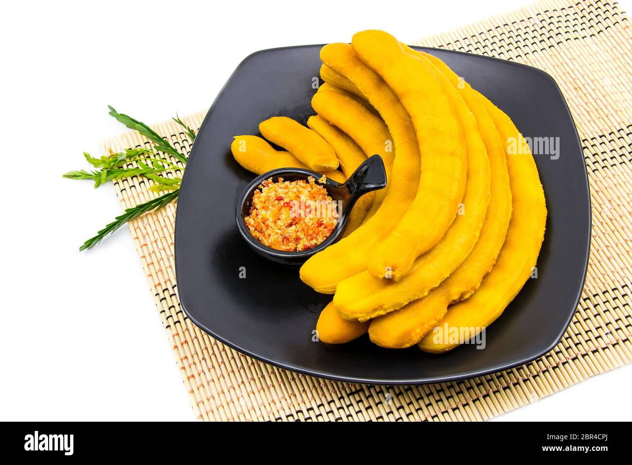 Pickled tamarind preserved in syrup on dish a black ceramic plate It is ...