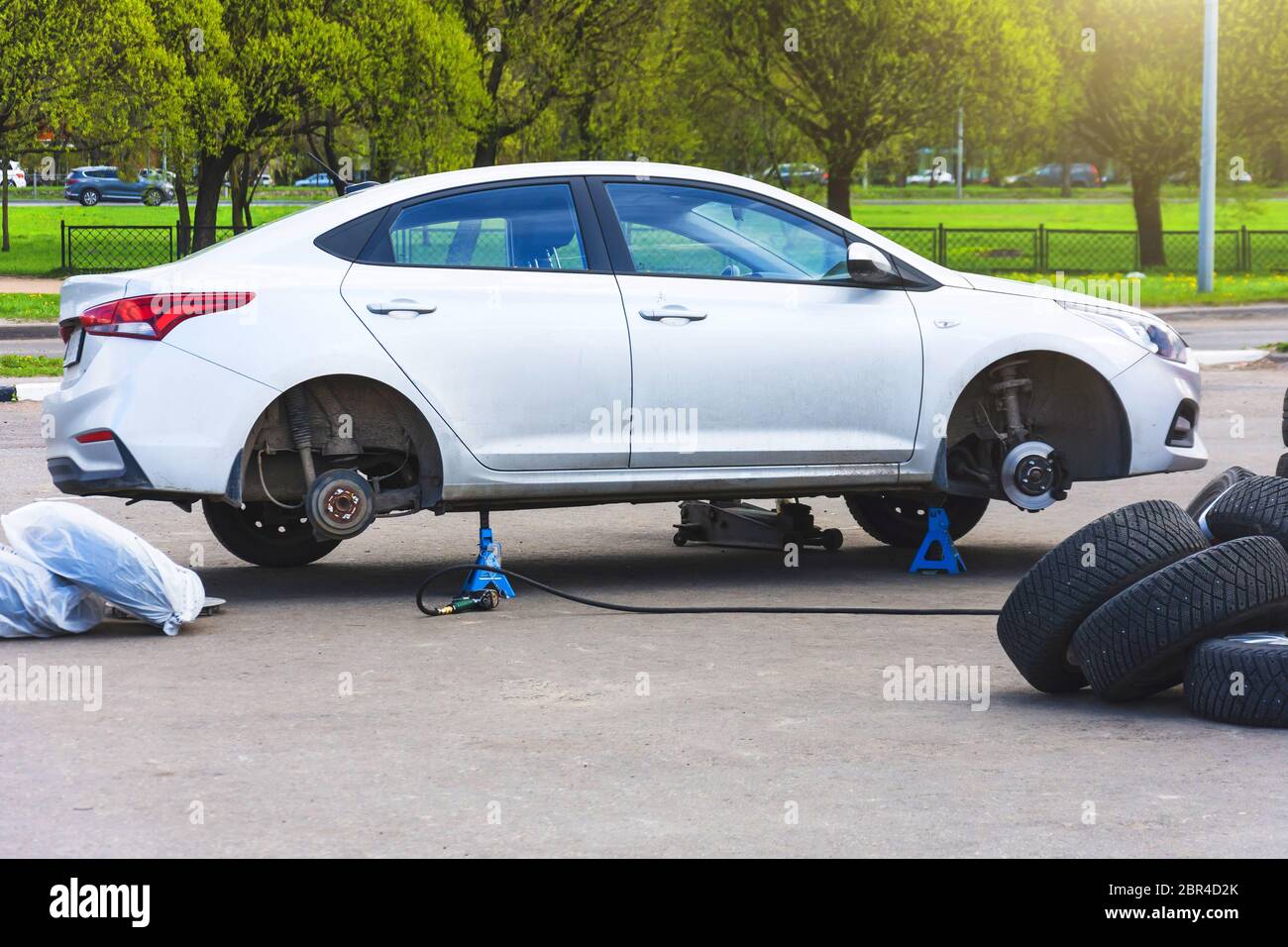 Replacing tires on wheels, a car without a wheels on a jack, express ...