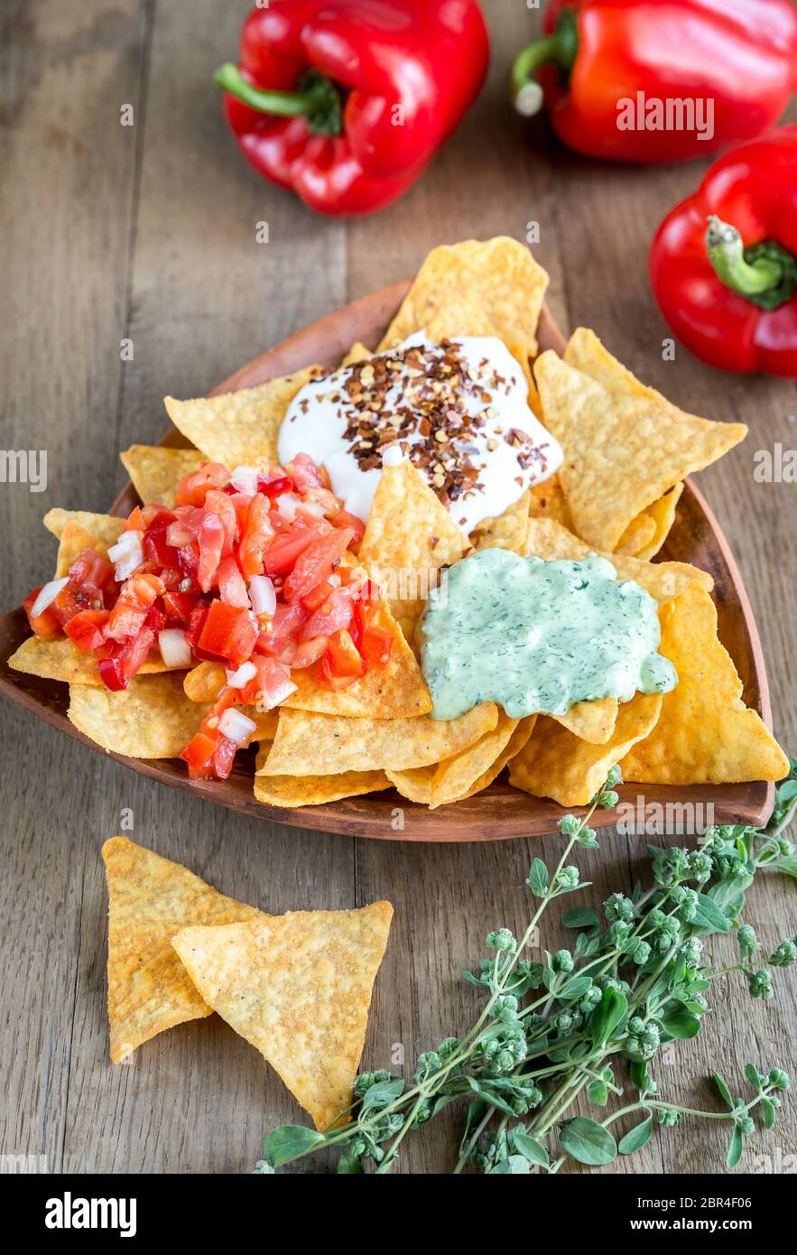 Cheese nachos with different types of sauce Stock Photo - Alamy