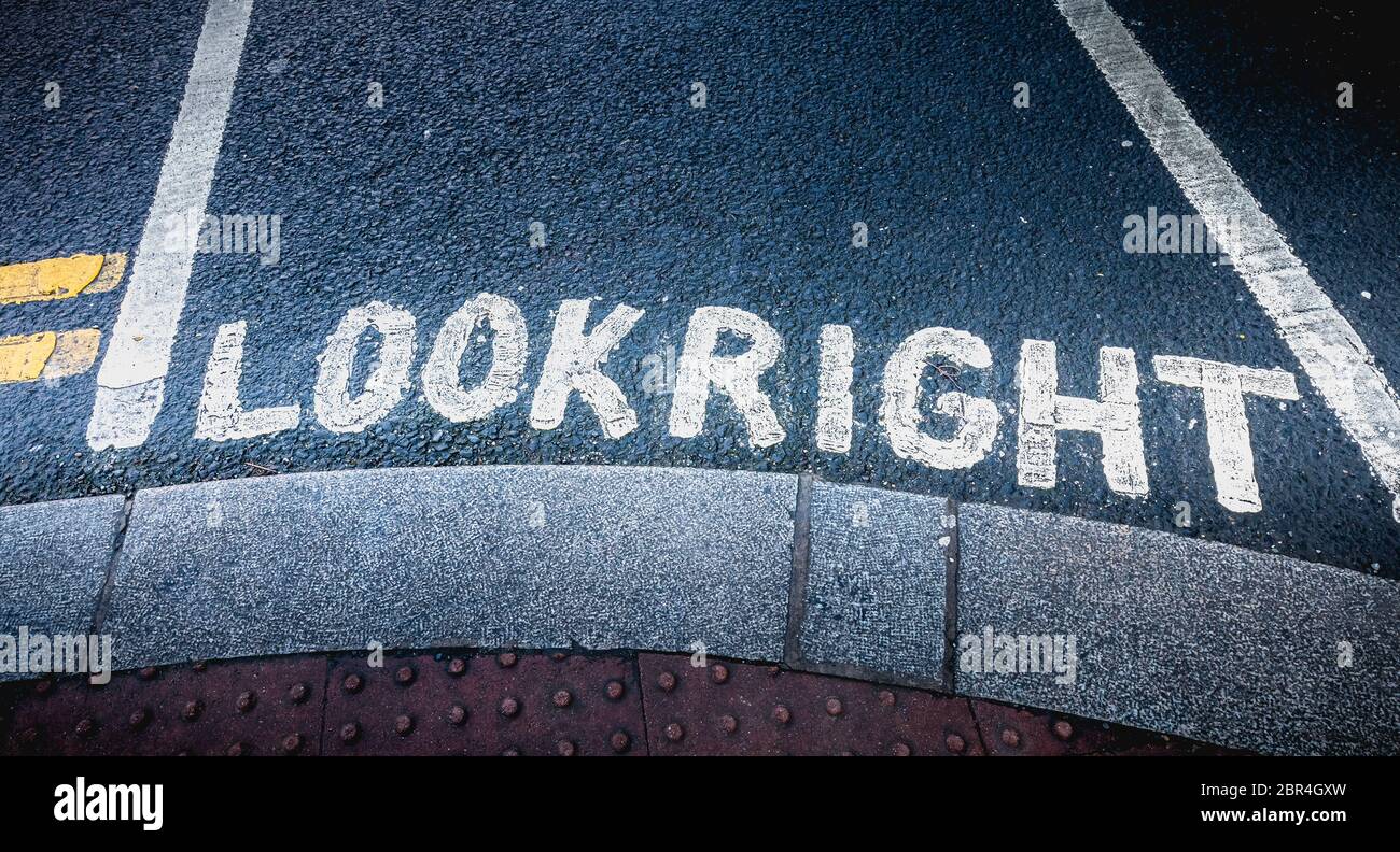 Look Right painted in white on the road on a pedestrian crossing in the ...