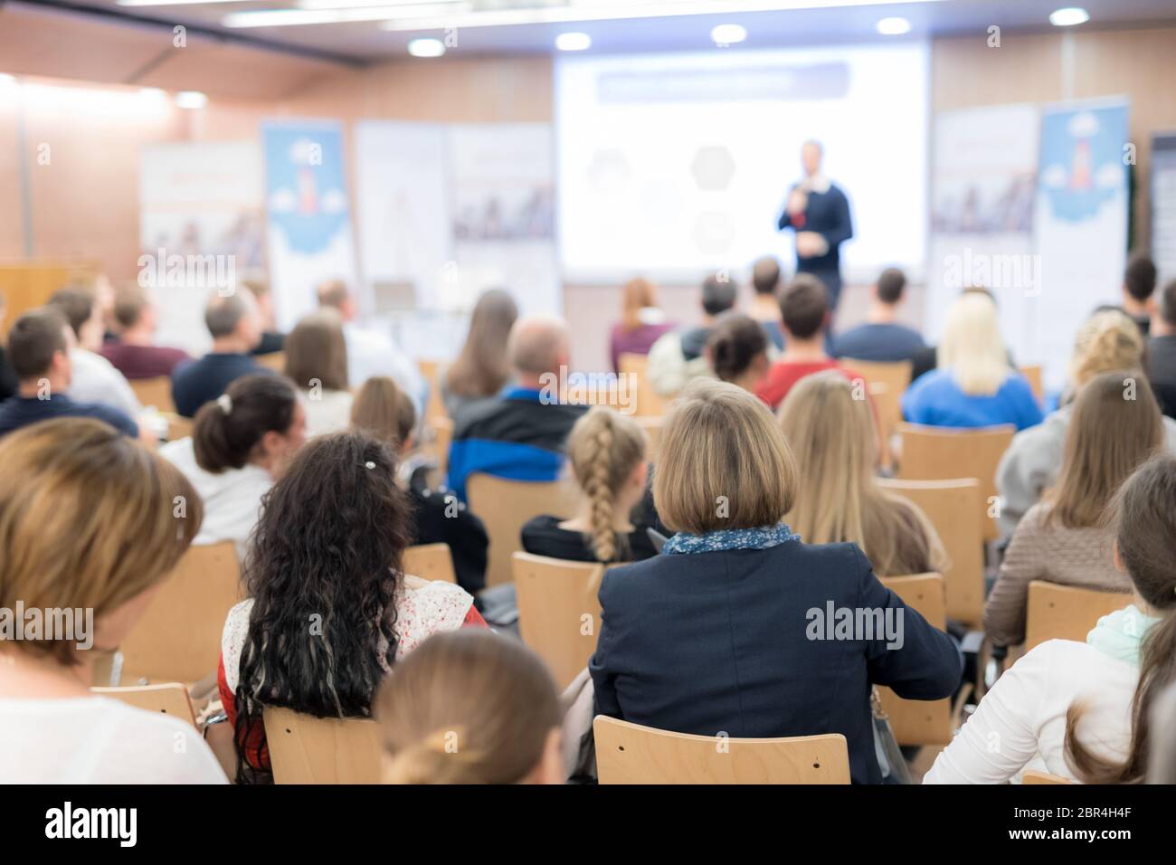Speaker giving a talk in conference hall at business event. Audience at ...