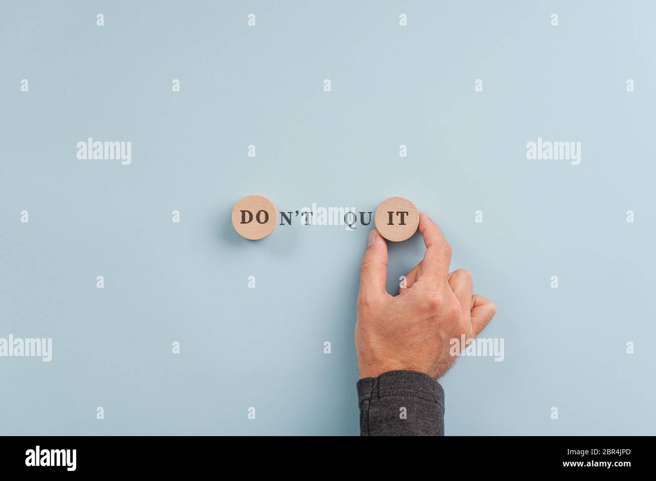 Male hand making a Don't quit sign in combination of handwriting and ...