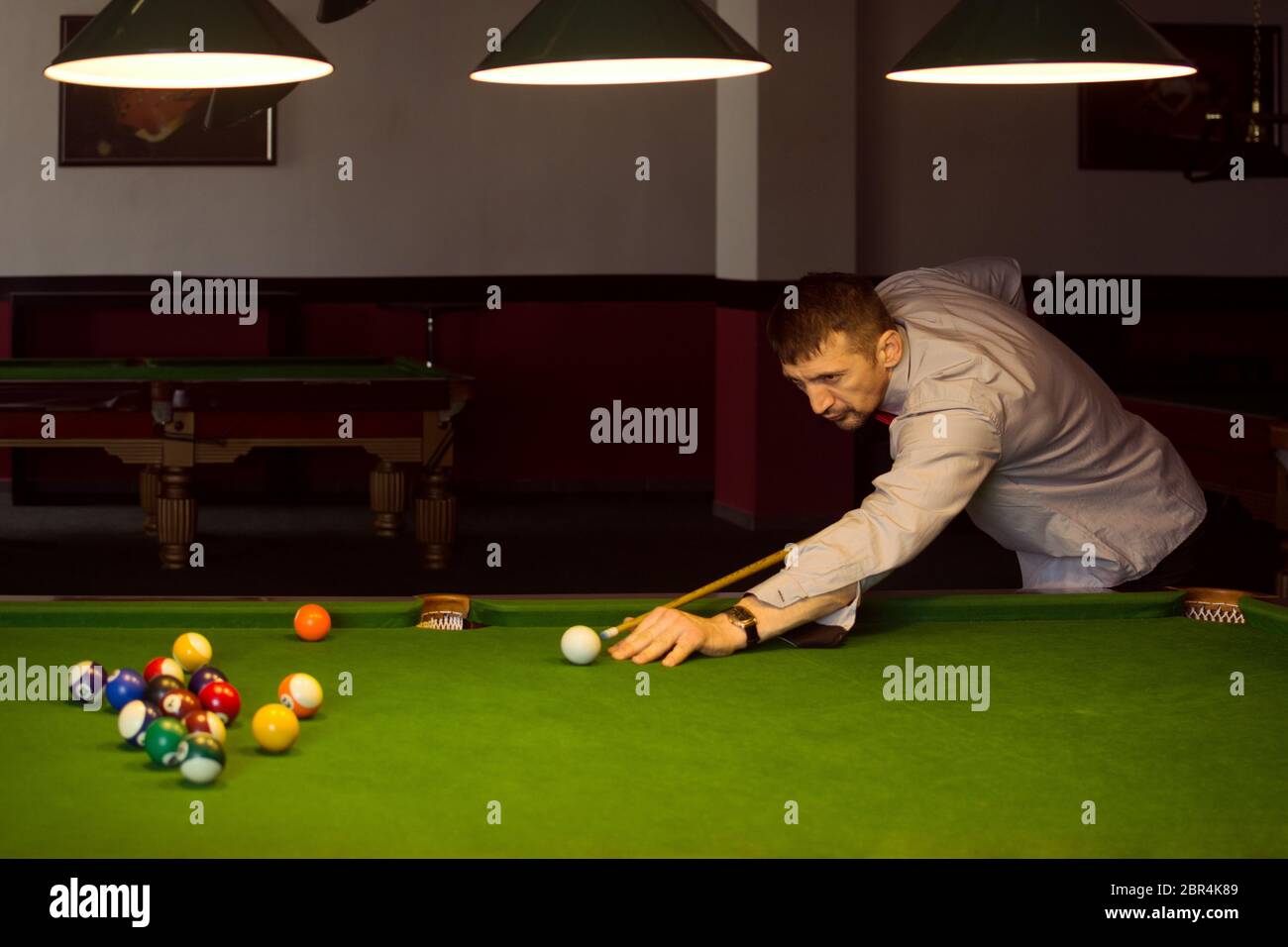 The pool gamer is playing snooker in billiard club indoors Stock Photo ...