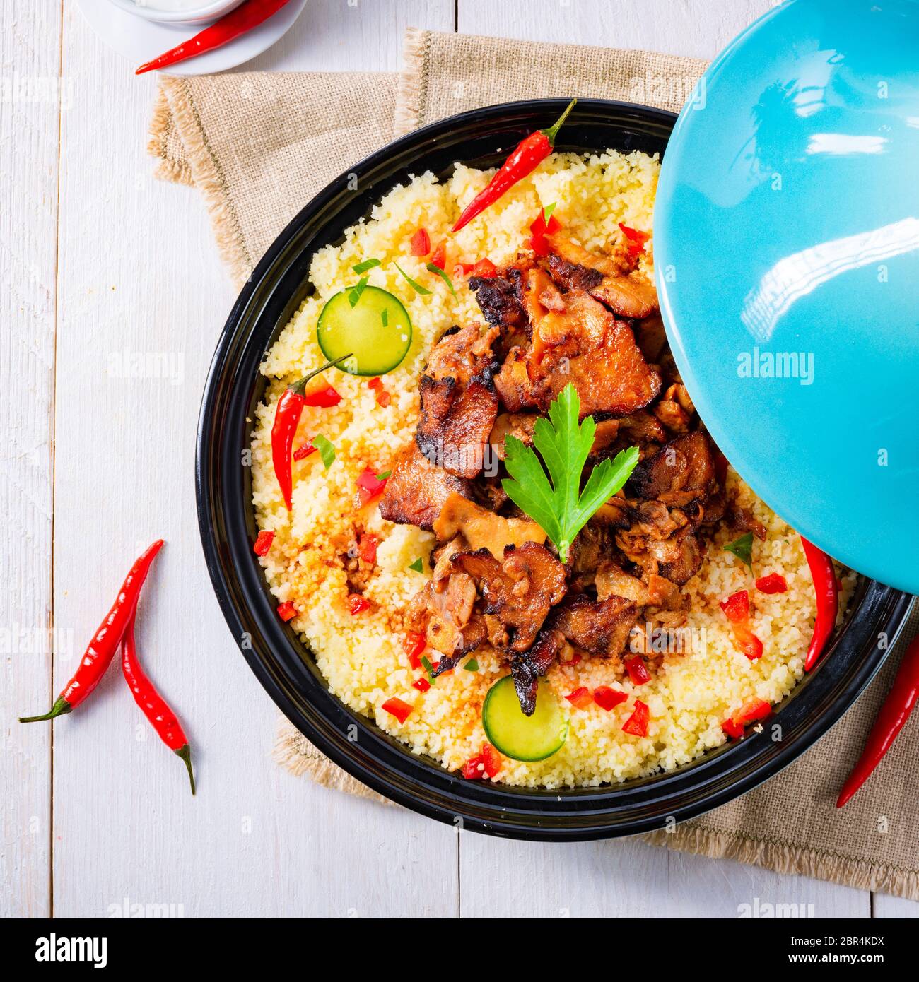 Tajin with couscous, vegetables and meat on white background Stock ...