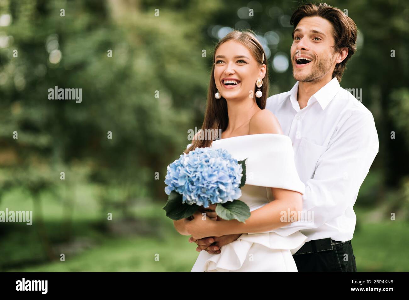 Woman in green hugging celebrating hi-res stock photography and images ...