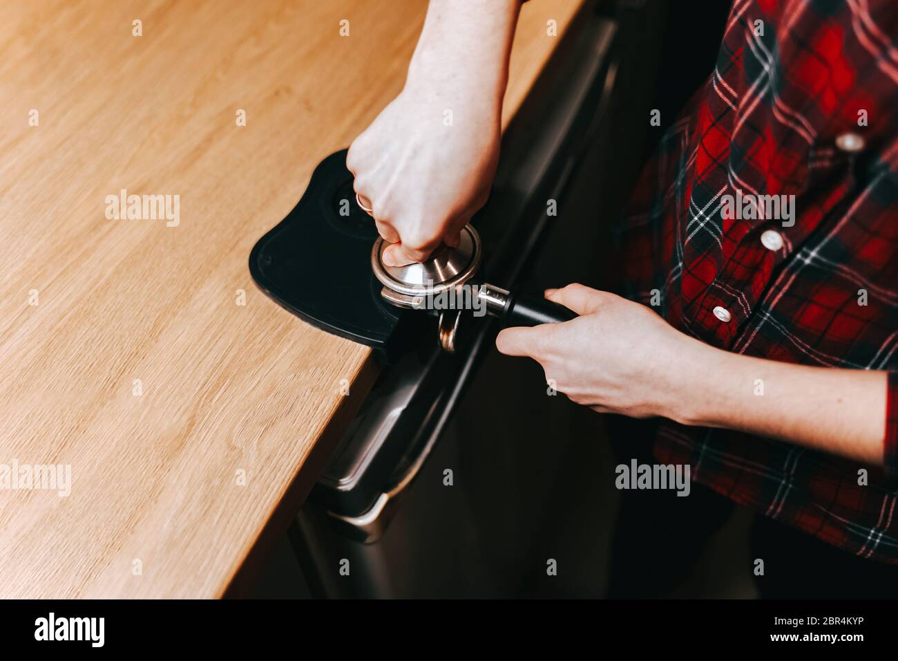 Barista presses ground coffee using tamper. Tool tamper. Coffee press ...