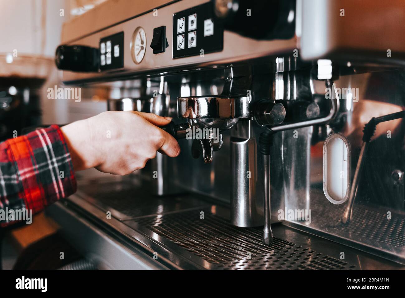 Barista makes aromatic coffee. Process of making latte coffee on a ...